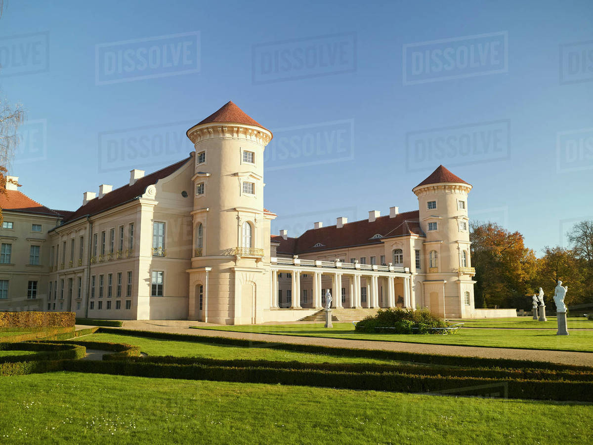 A grand historic mansion with two prominent towers and symmetrical ...