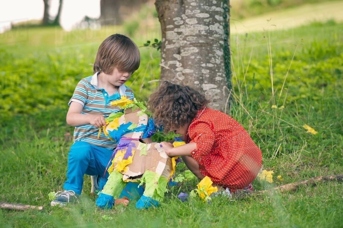 Children opening pinata at party - Royalty-free Stock Photo | Dissolve
