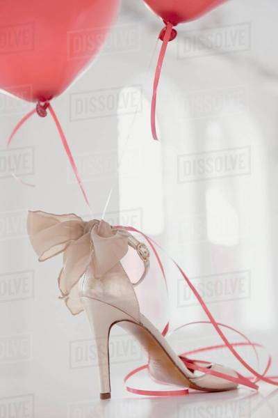 Balloons attached to high heel - Stock Photo - Dissolve