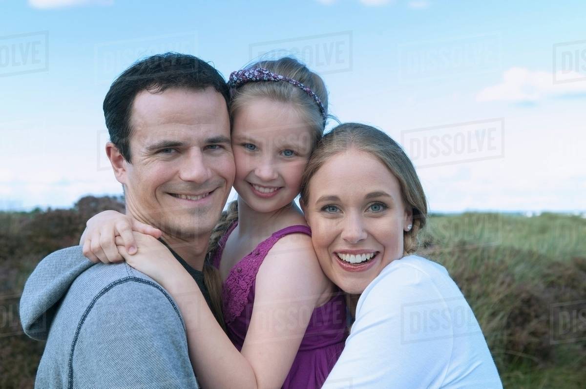 Family smiling together outdoors - Stock Photo - Dissolve