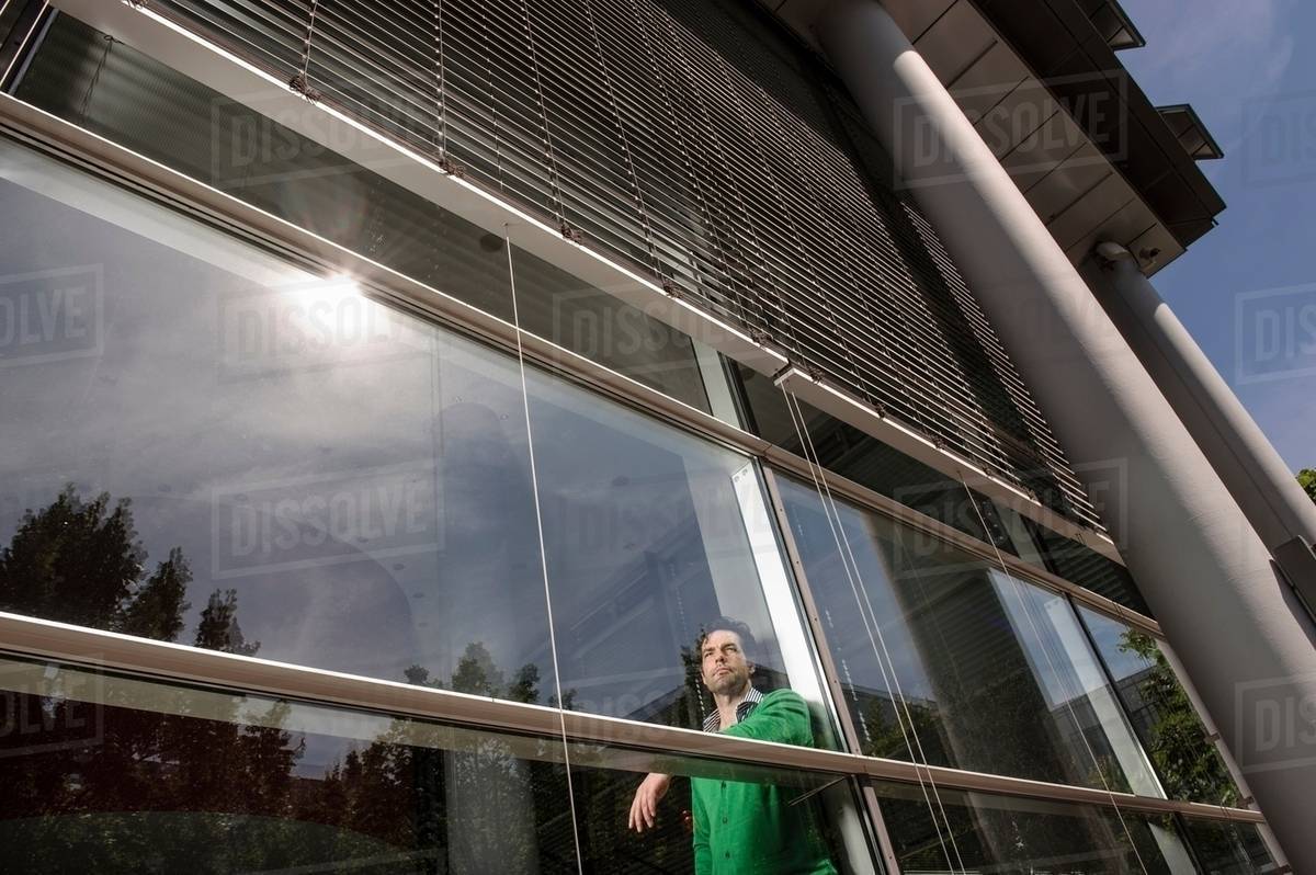 Man standing behind window - Stock Photo - Dissolve