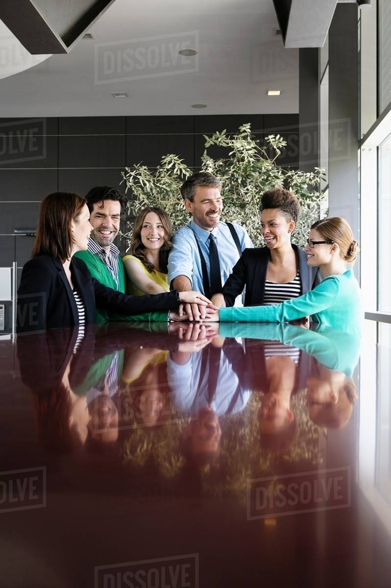 Business people smiling at table - Stock Photo - Dissolve