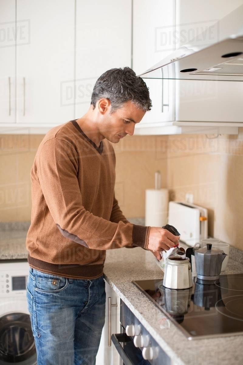 Man making coffee in kitchen - Stock Photo - Dissolve