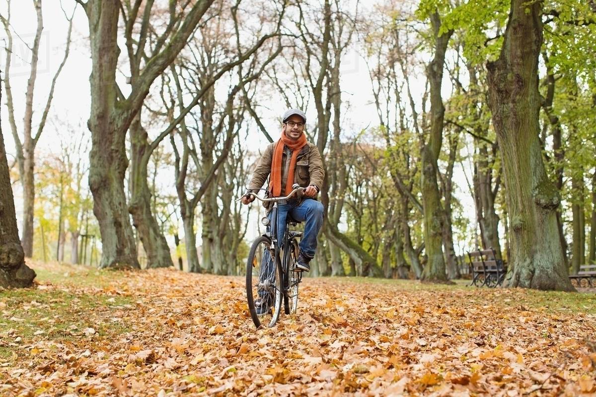 Man riding bicycle in park - Stock Photo - Dissolve