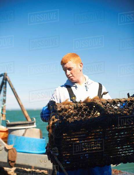 Fisherman at work on boat - Royalty-free Stock Photo | Dissolve