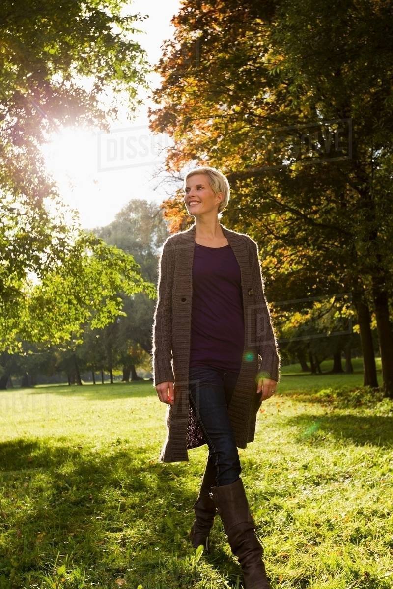 Woman walking in park - Royalty-free Stock Photo | Dissolve