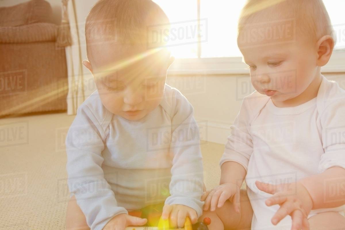 Babies playing with toys together - Royalty-free Stock Photo | Dissolve