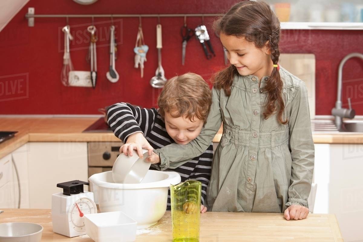 Children cooking together in kitchen - Royalty-free Stock Photo | Dissolve