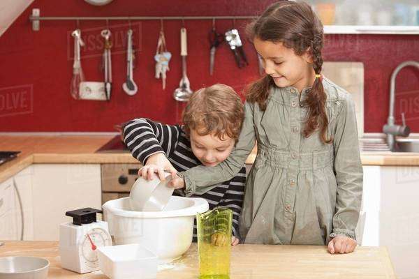 Children cooking together in kitchen - Royalty-free Stock Photo | Dissolve