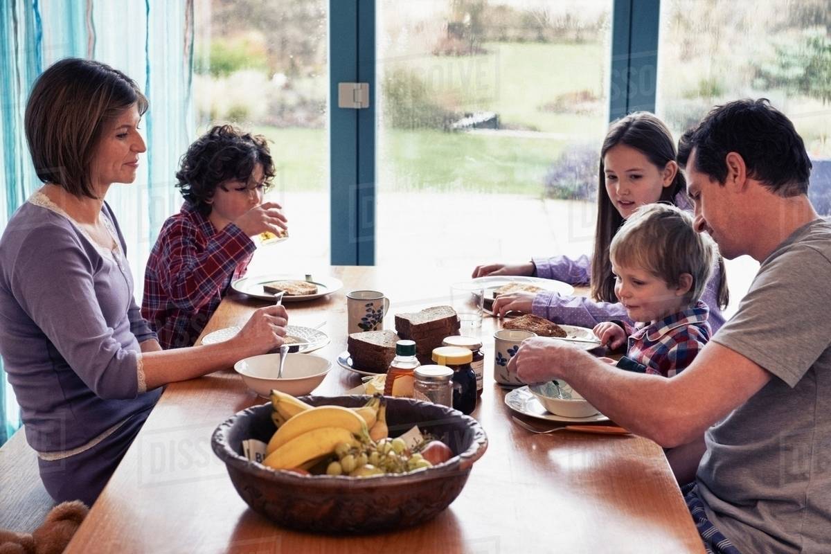 Family having dinner together at table - Royalty-free Stock Photo ...