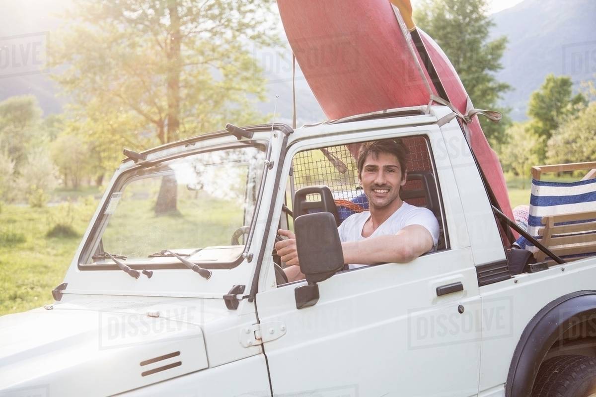 Young man driving off road vehicle - Royalty-free Stock Photo | Dissolve