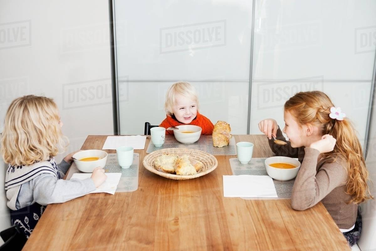 Children eating lunch at table - Royalty-free Stock Photo | Dissolve