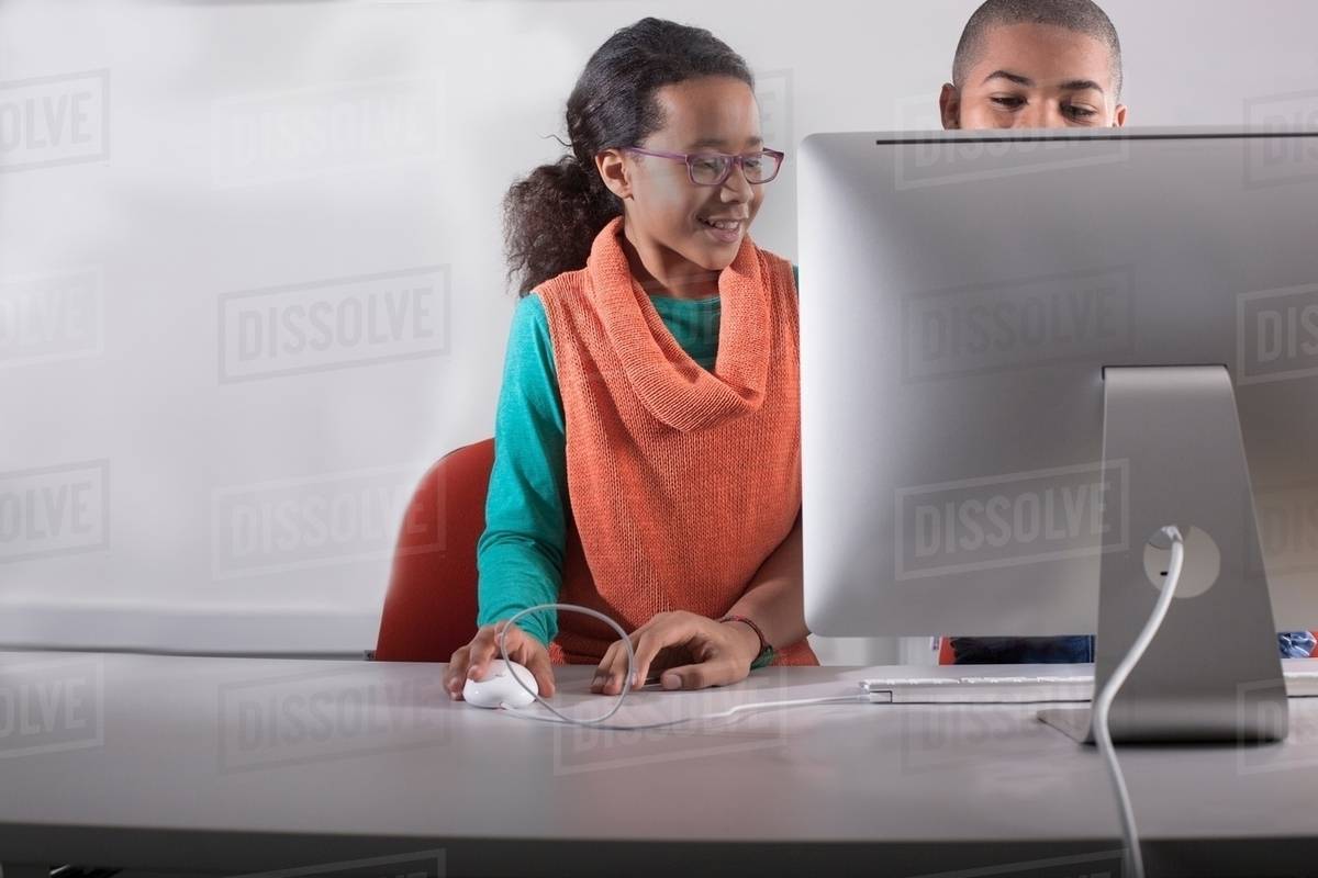 Children using computer together - Stock Photo - Dissolve