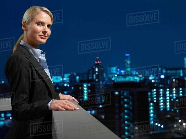 Smart lady in corporate environment overlooking the city - Royalty-free ...