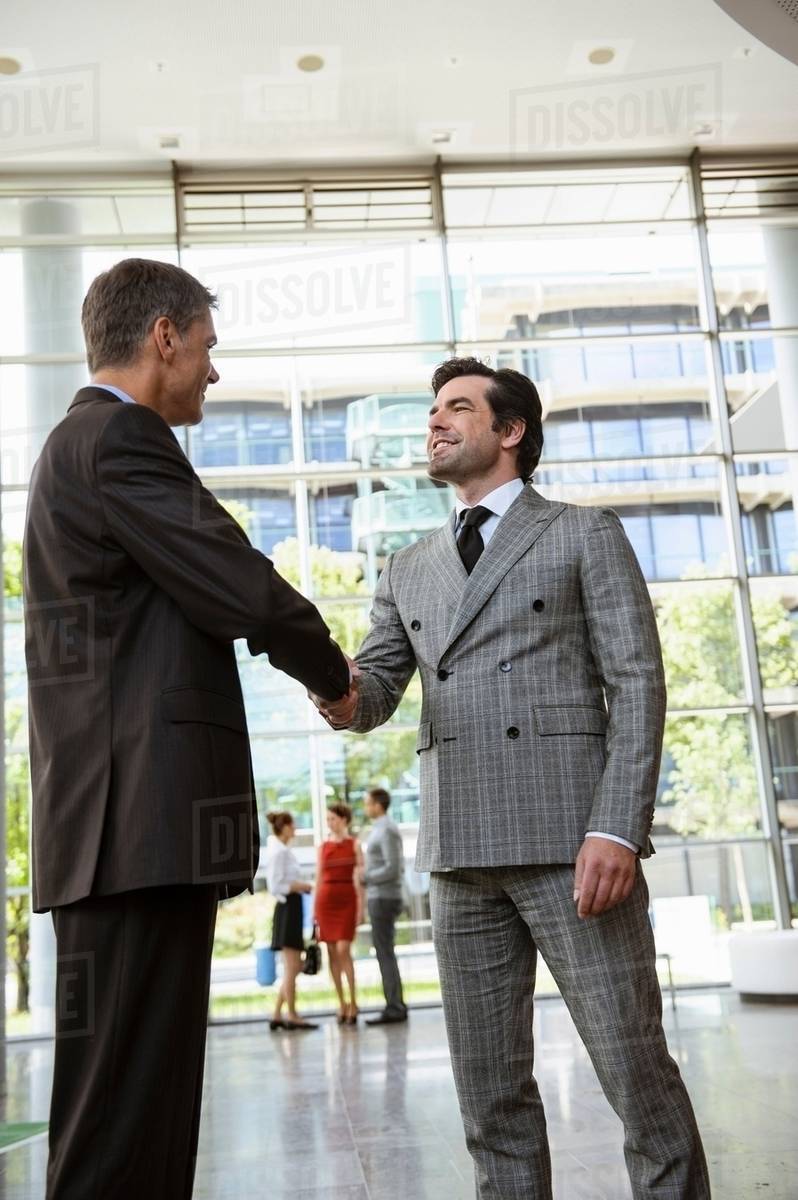 Two businessmen shaking hands - Stock Photo - Dissolve