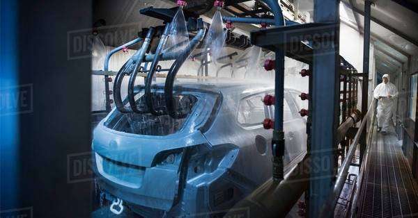 Car bodies being cleaned prior to spraying in car factory - Stock Photo ...