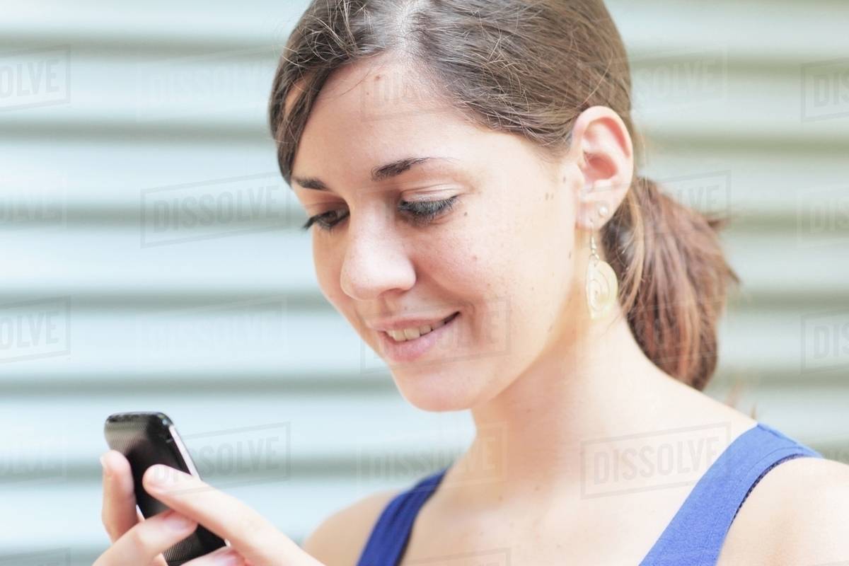 Teenage girl using cell phone - Royalty-free Stock Photo | Dissolve