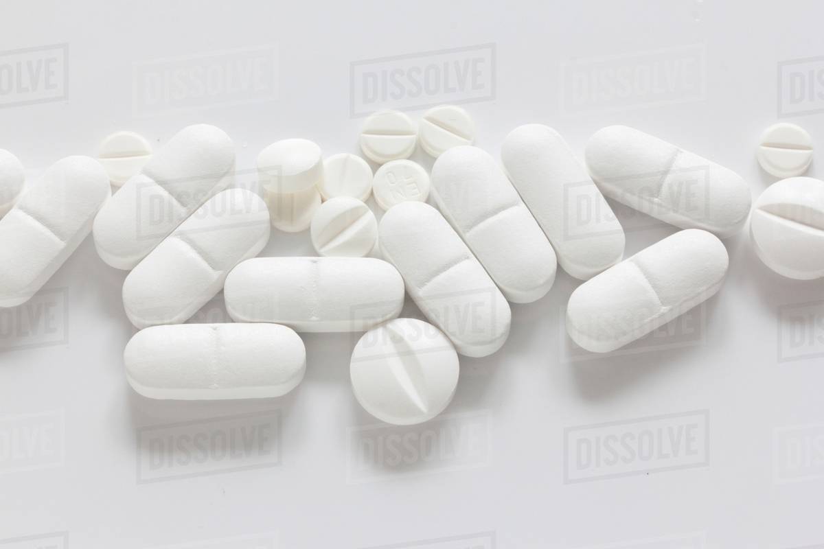 Pile of pills on counter - Royalty-free Stock Photo | Dissolve