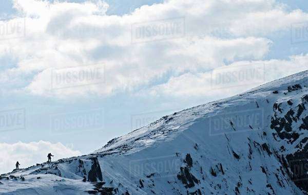 Two climbers silhouetted along snow covered ridge, Castell y Geifr ...