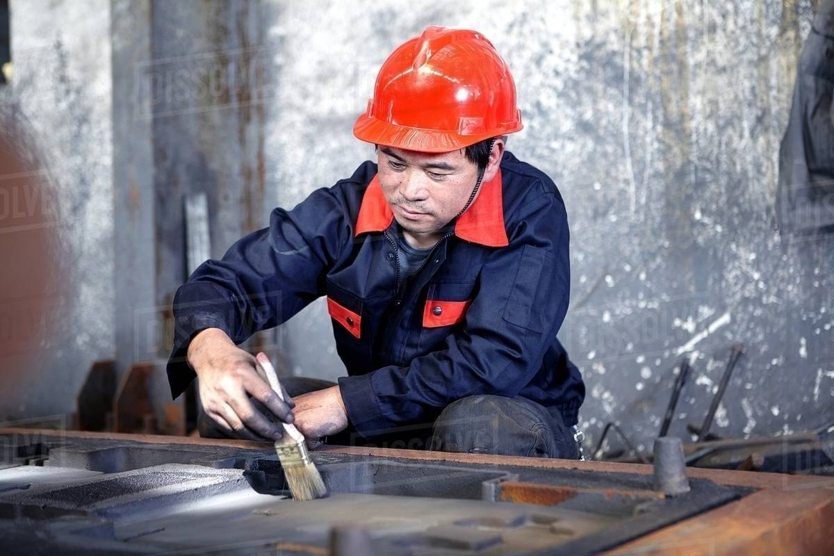 Working in cast iron foundry - Stock Photo - Dissolve