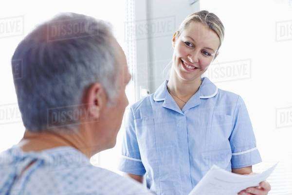 Nurse having conversation with patient - Royalty-free Stock Photo ...