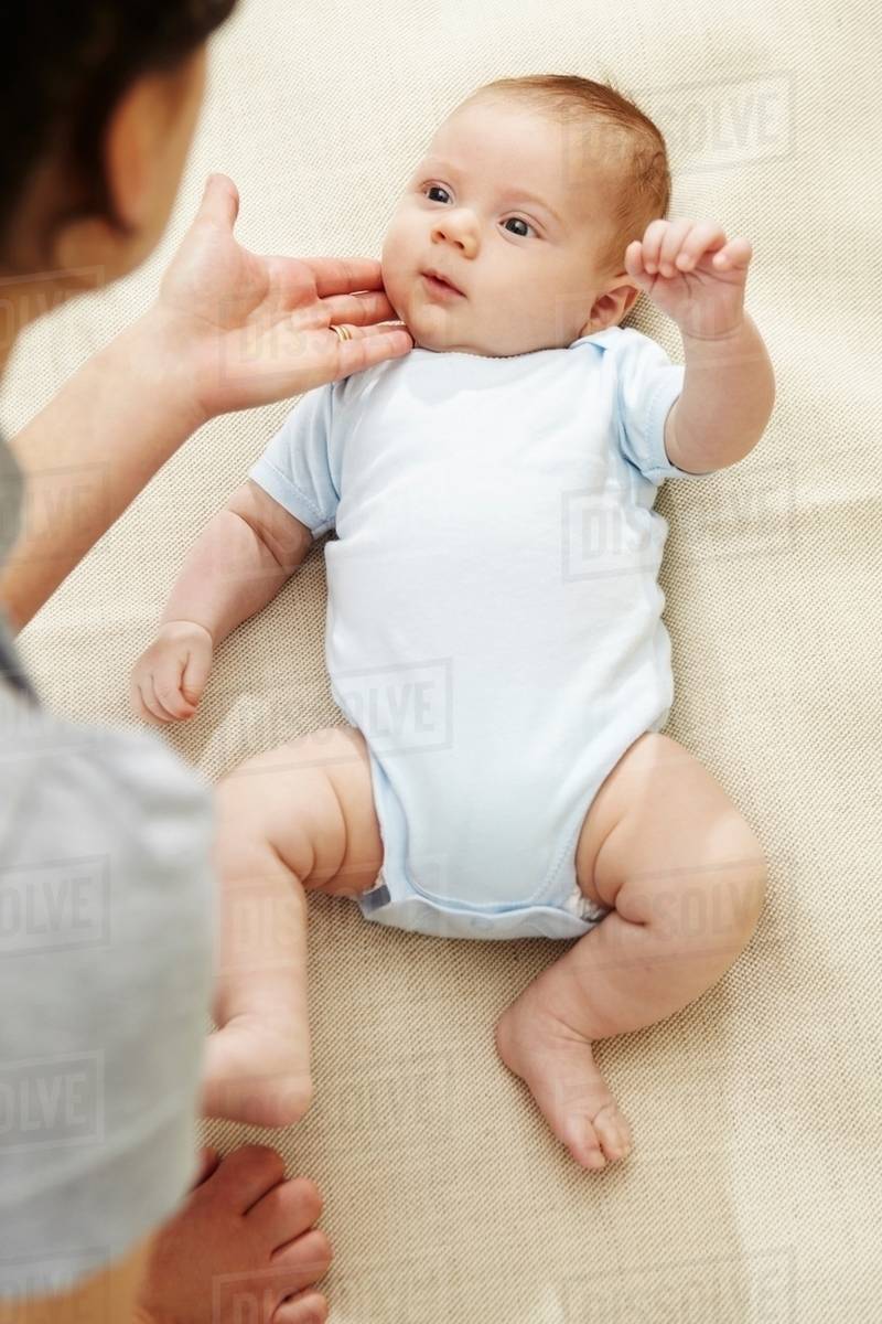 Mother touching baby boy's cheek - Royalty-free Stock Photo | Dissolve