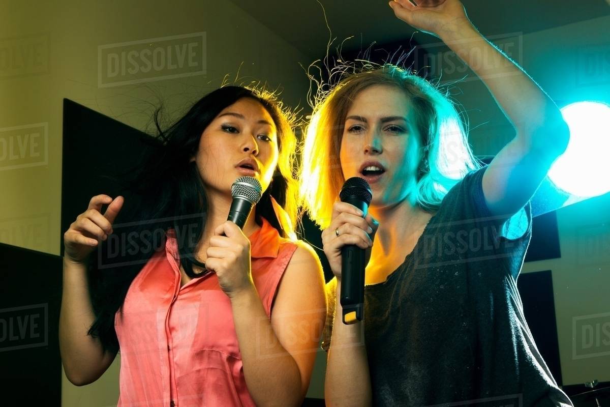 Women dancing and singing - Royalty-free Stock Photo | Dissolve