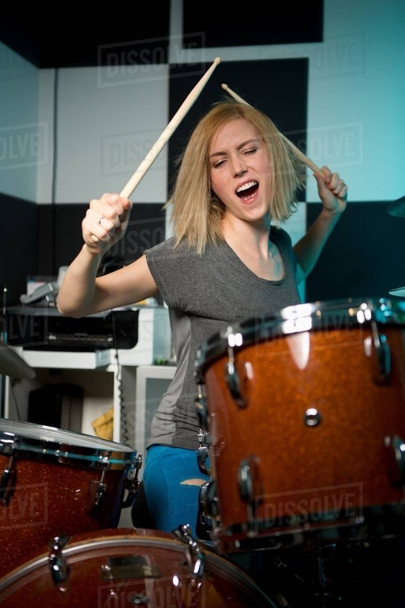 Female drummer performing - Royalty-free Stock Photo | Dissolve