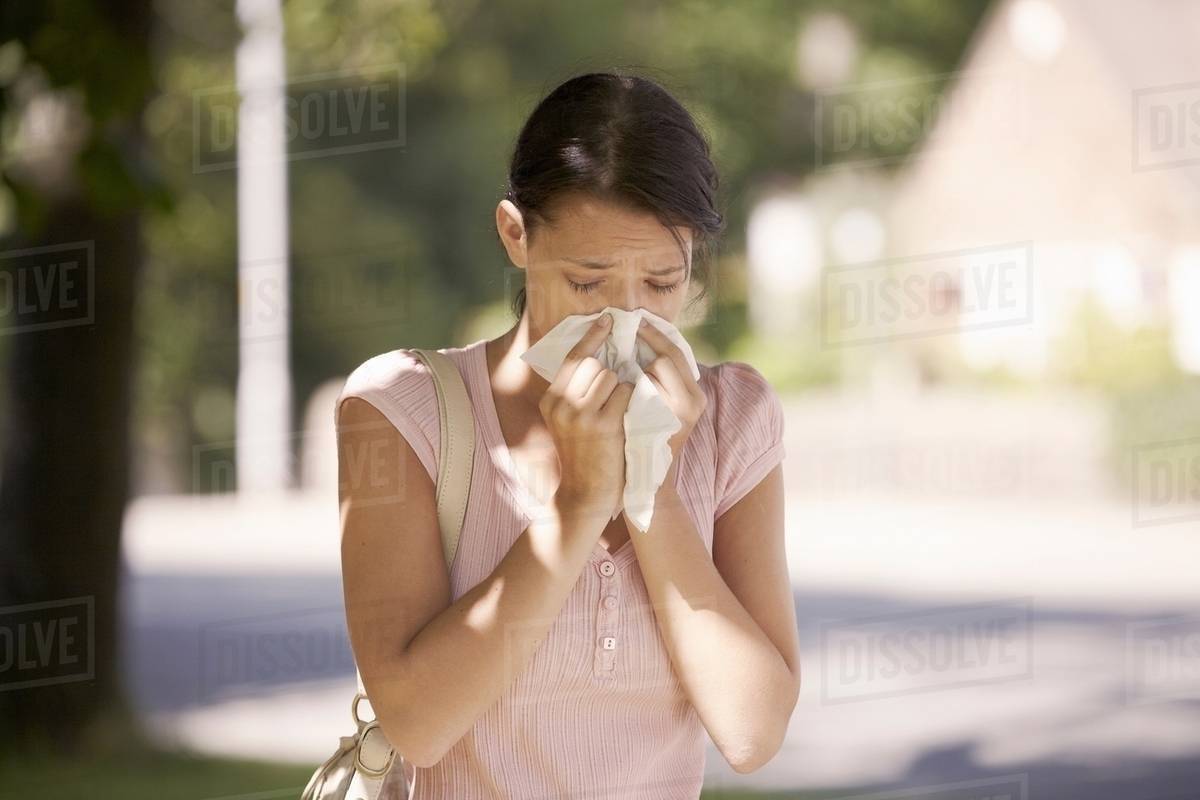 Woman suffering from hay fever - Stock Photo - Dissolve