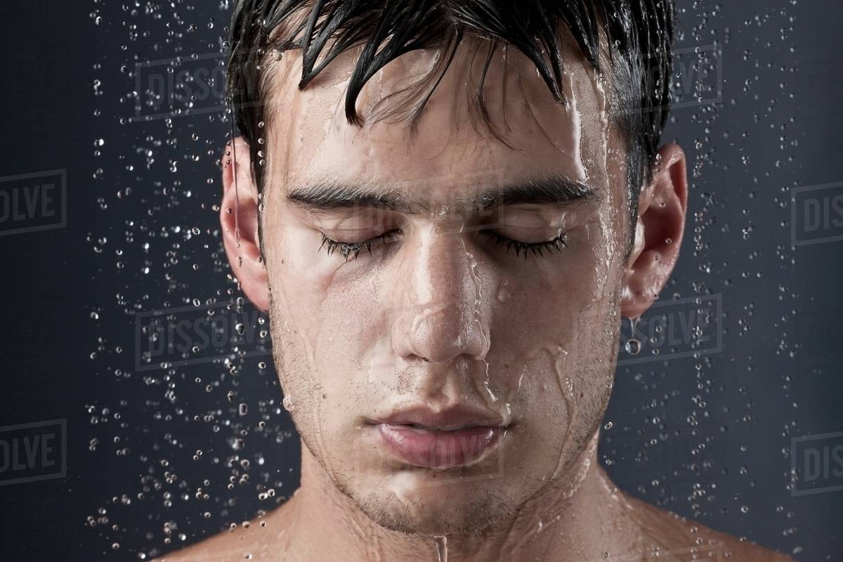Young man covered with water droplets - Royalty-free Stock Photo | Dissolve
