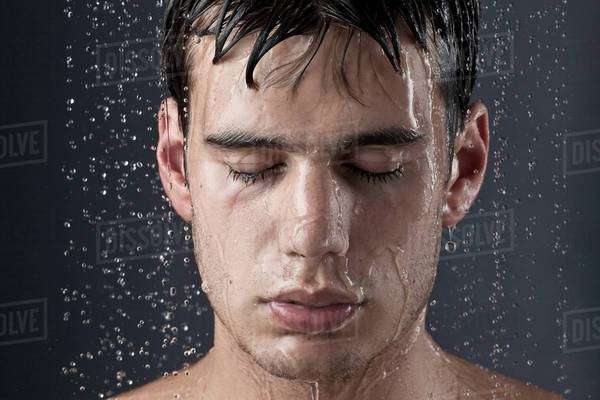 Young man covered with water droplets - Royalty-free Stock Photo | Dissolve