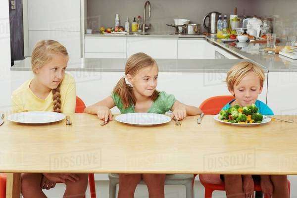 Children staring at full plate of greens - Royalty-free Stock Photo ...