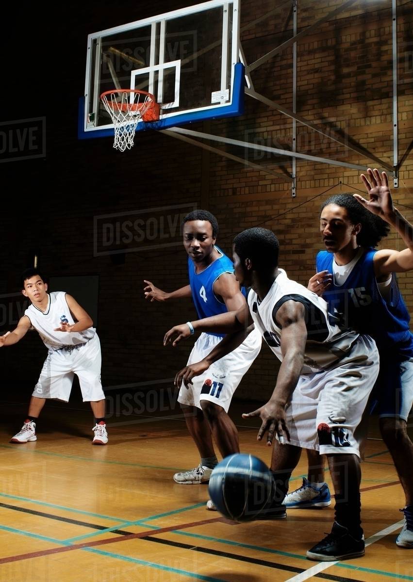 Basketball players playing on court - Royalty-free Stock Photo | Dissolve