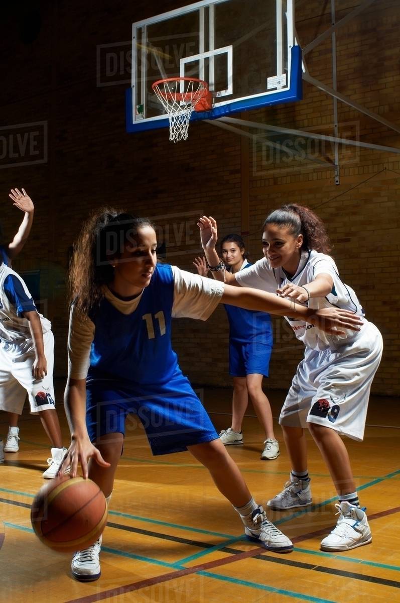 Basketball player defending opponent - Stock Photo - Dissolve