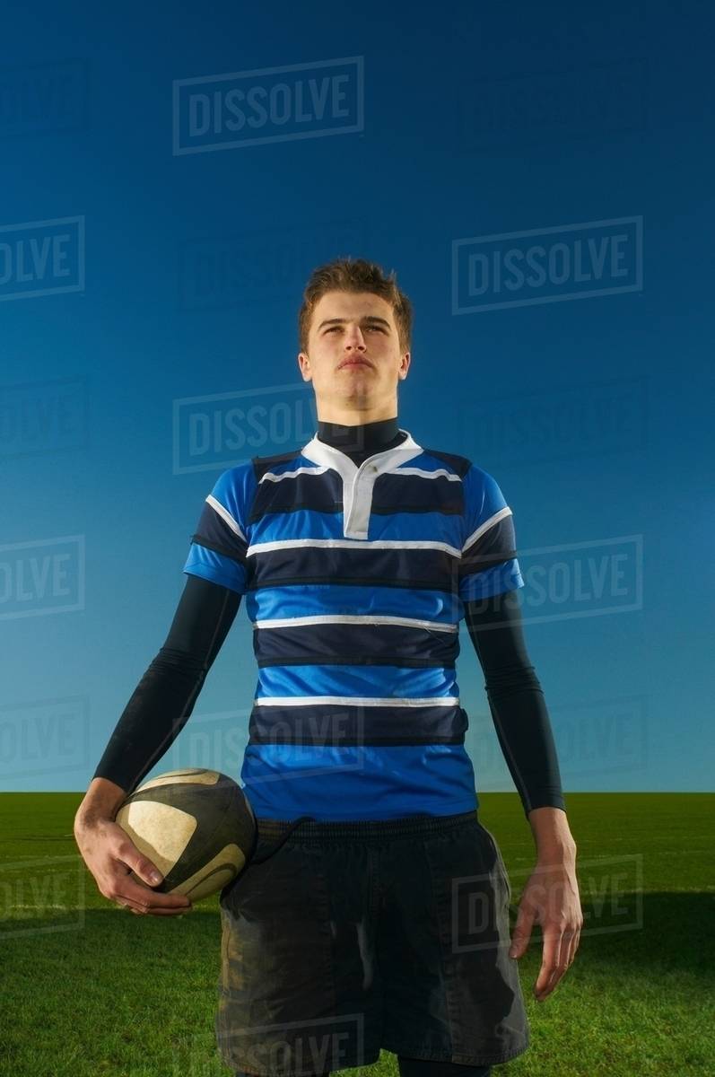 Portrait of young man holding rugby ball - Royalty-free Stock Photo ...