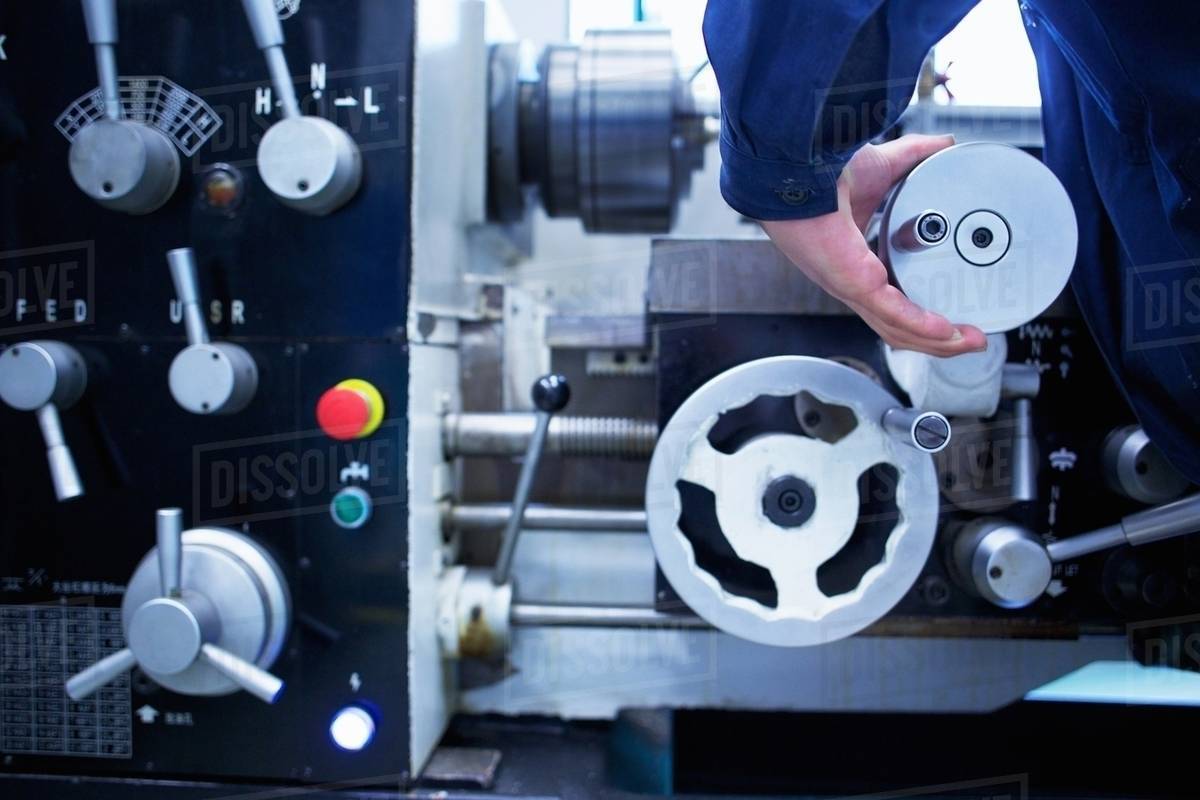 Cropped image of hand operating machinery - Stock Photo - Dissolve