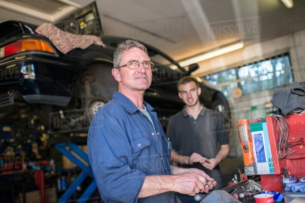 Two mechanics in garage - Stock Photo - Dissolve