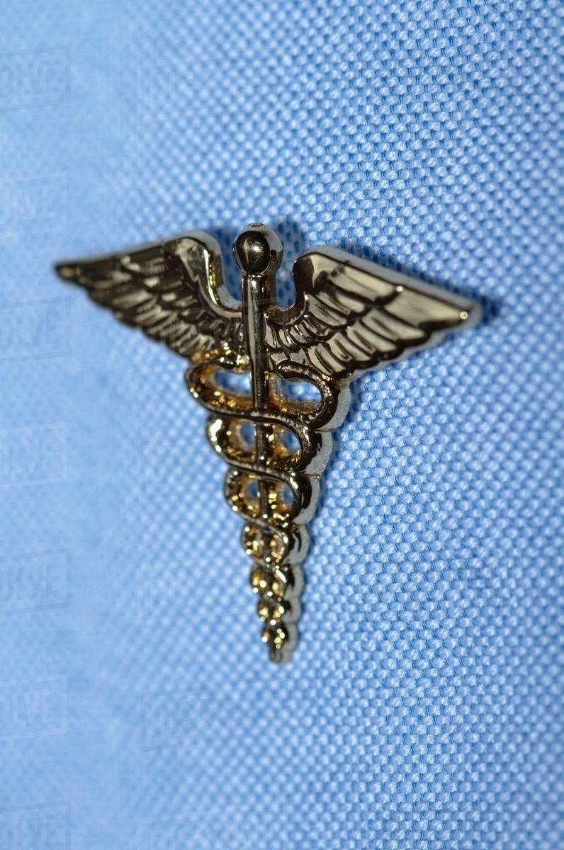Caduceus pin attached to a shirt - Royalty-free Stock Photo | Dissolve