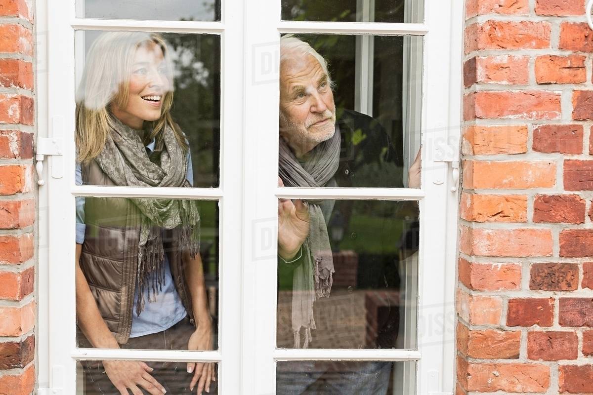 Father and daughter looking through window - Royalty-free Stock Photo ...