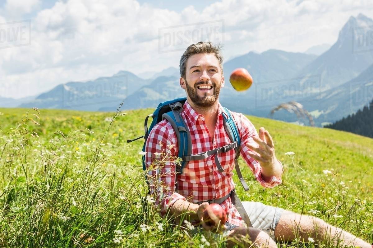 Man throwing apple, Tyrol, Austria - Stock Photo - Dissolve