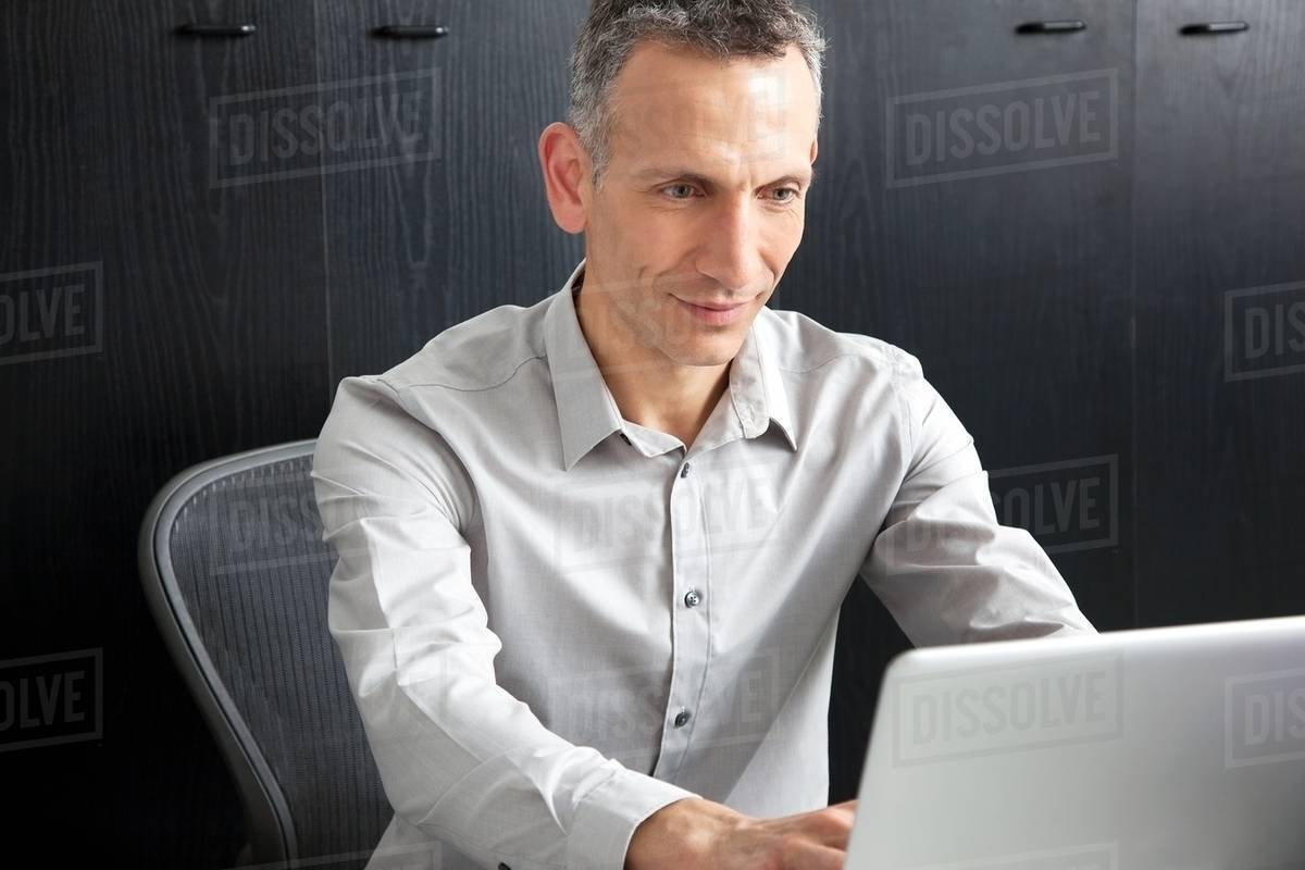 Businessman using laptop - Royalty-free Stock Photo | Dissolve
