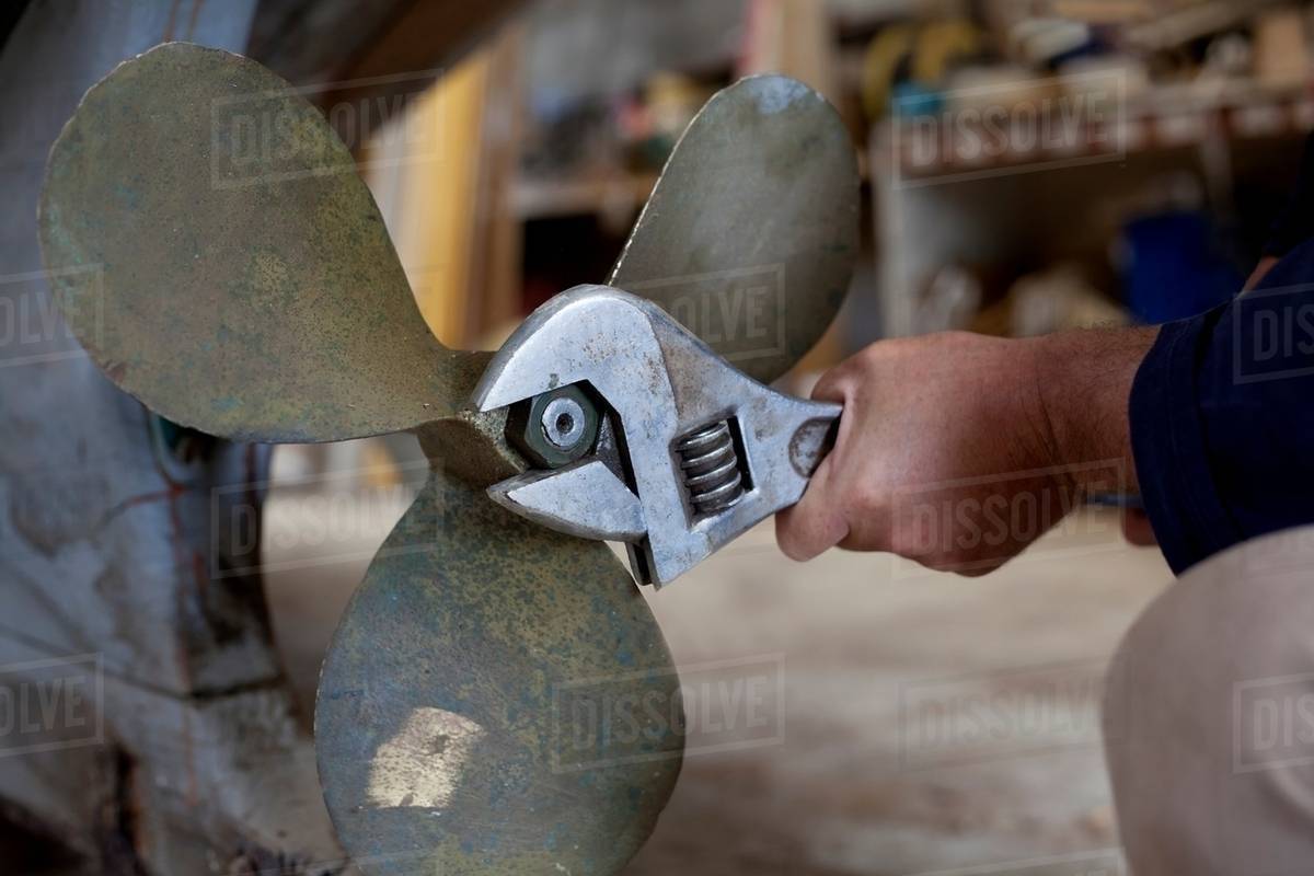 Man tightening boat propeller in workshop - Royalty-free Stock Photo ...