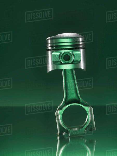 Car piston on green background - Royalty-free Stock Photo | Dissolve