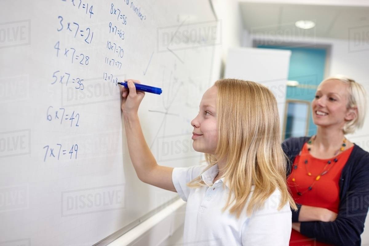 Schoolgirl doing multiplication on white board - Royalty-free Stock ...