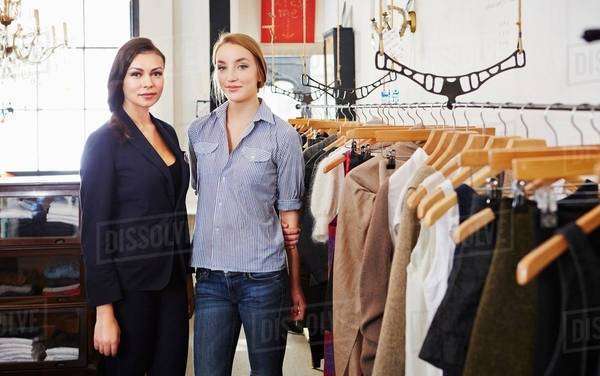 Young women standing in clothes shop - Royalty-free Stock Photo | Dissolve