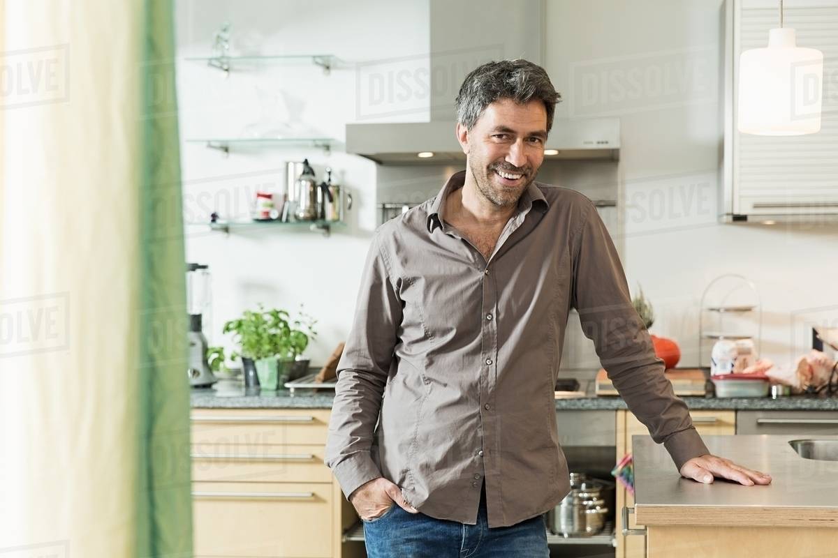 Man standing in kitchen - Royalty-free Stock Photo | Dissolve