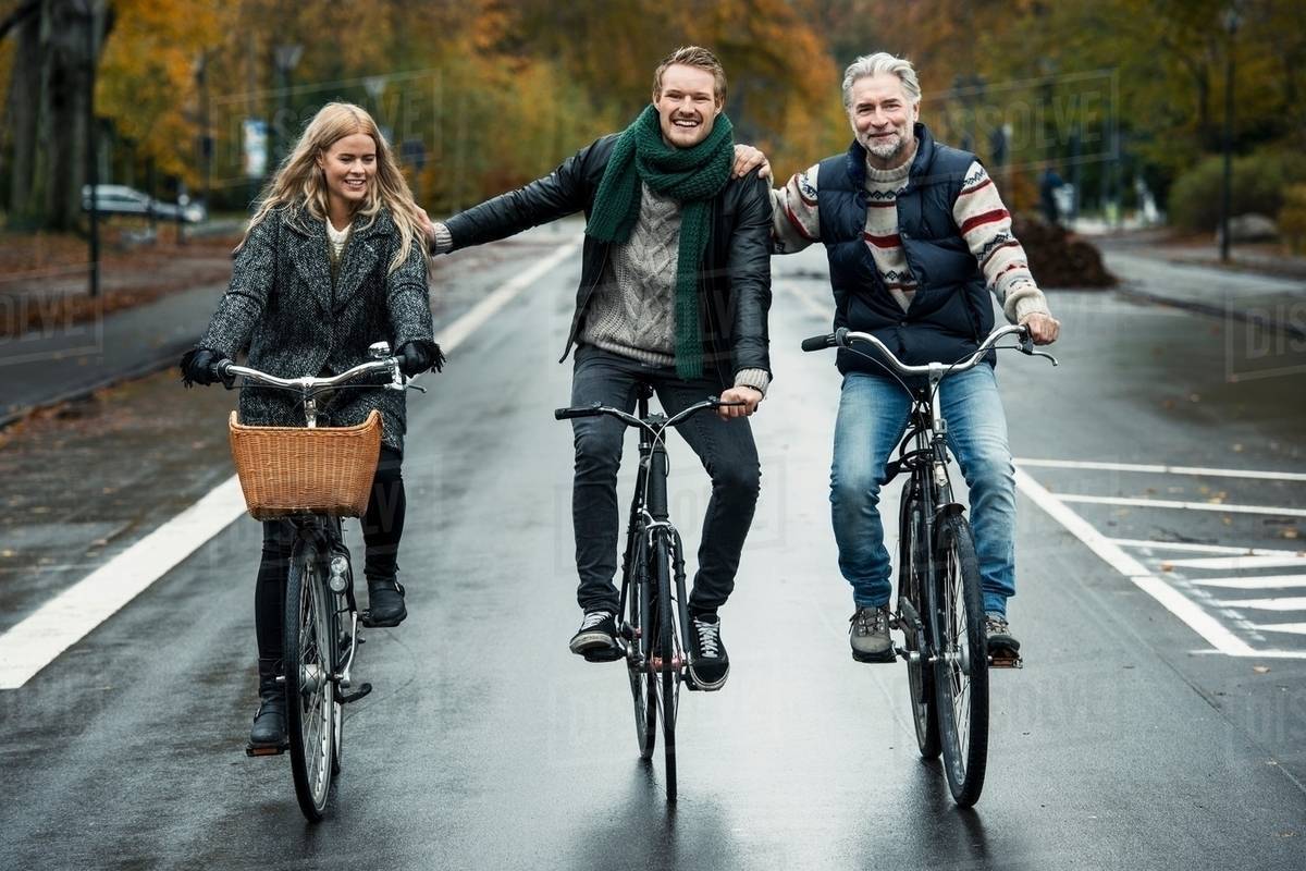 Friends cycling on street - Royalty-free Stock Photo | Dissolve
