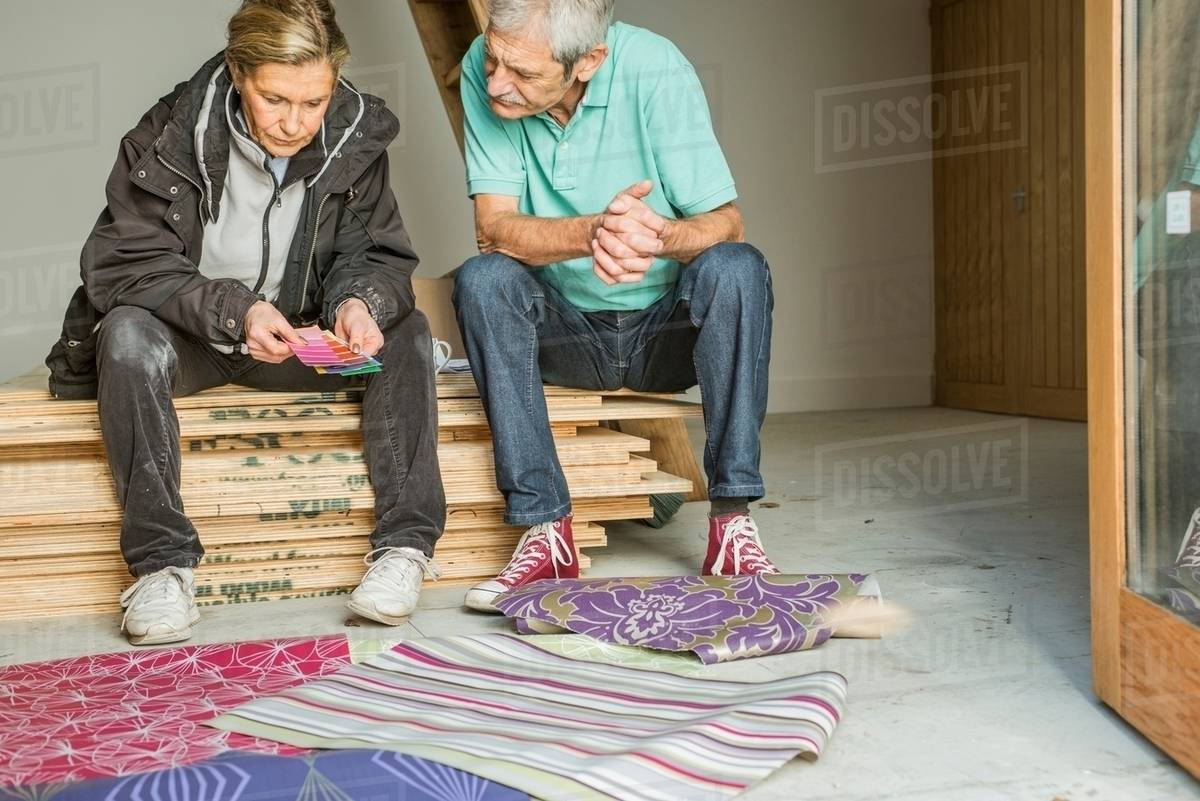 Senior couple making decision on wallpaper - Royalty-free Stock Photo ...