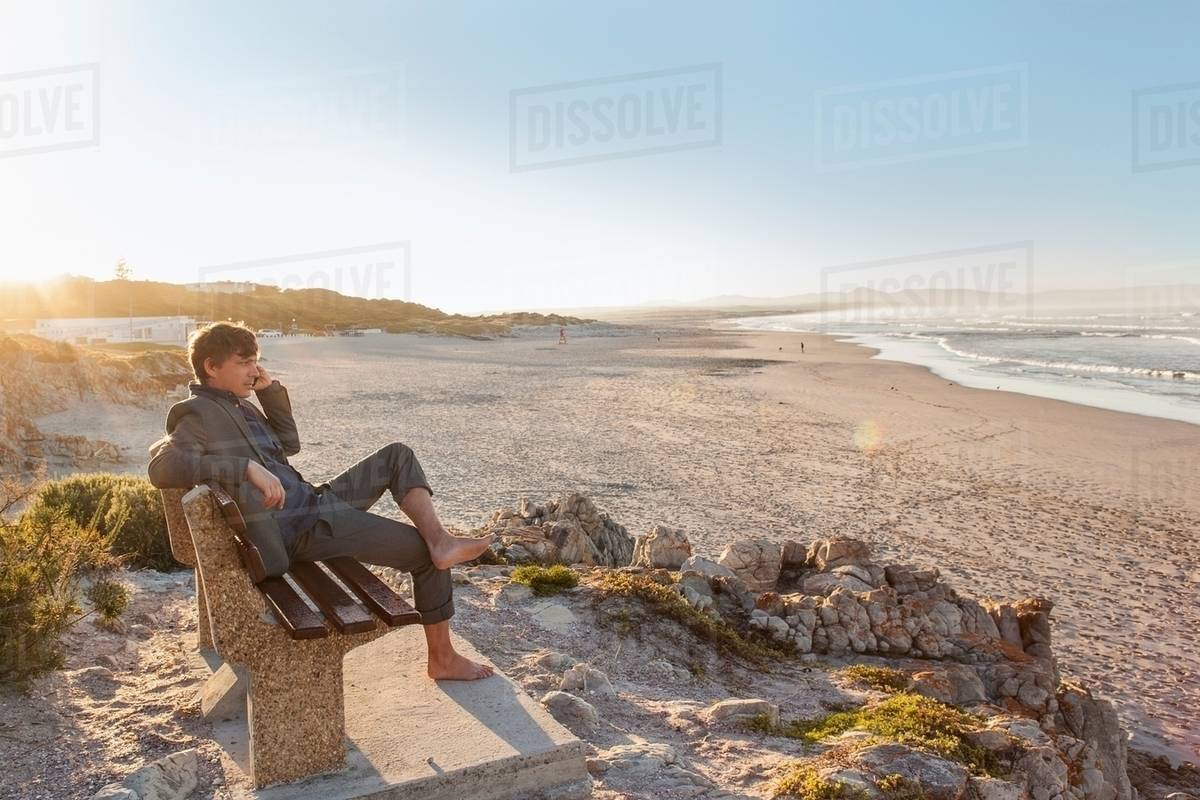 Man relaxing on beach bench - Royalty-free Stock Photo | Dissolve