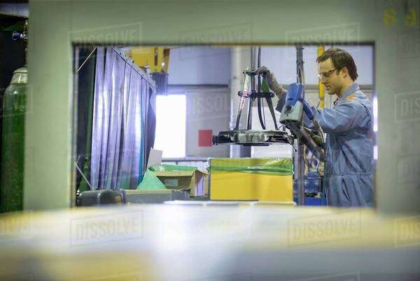 Worker on packing line in factory - Stock Photo - Dissolve